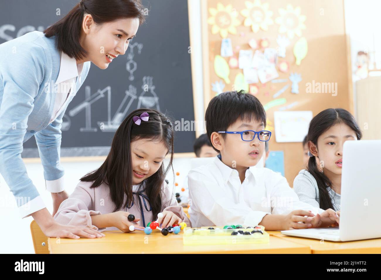 Female teachers and students use computers in the classroom Stock Photo ...