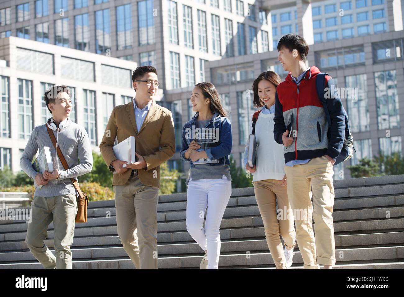 The teacher and the student walking and talking Stock Photo - Alamy