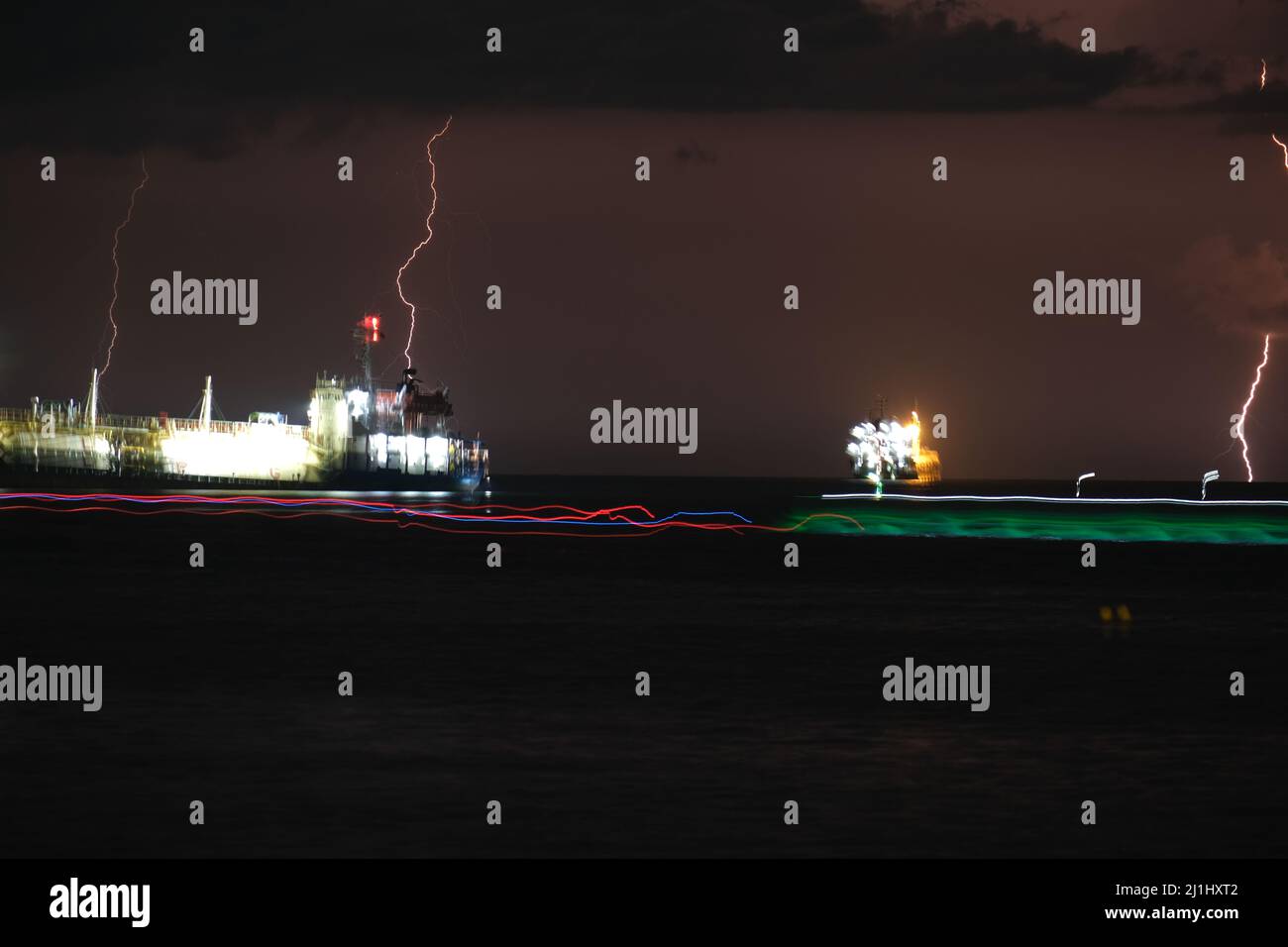 Lightnings are striking big ships during heavy storm at night Stock ...