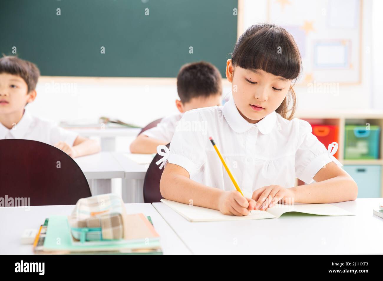 Elementary school students in the classroom learning Stock Photo - Alamy