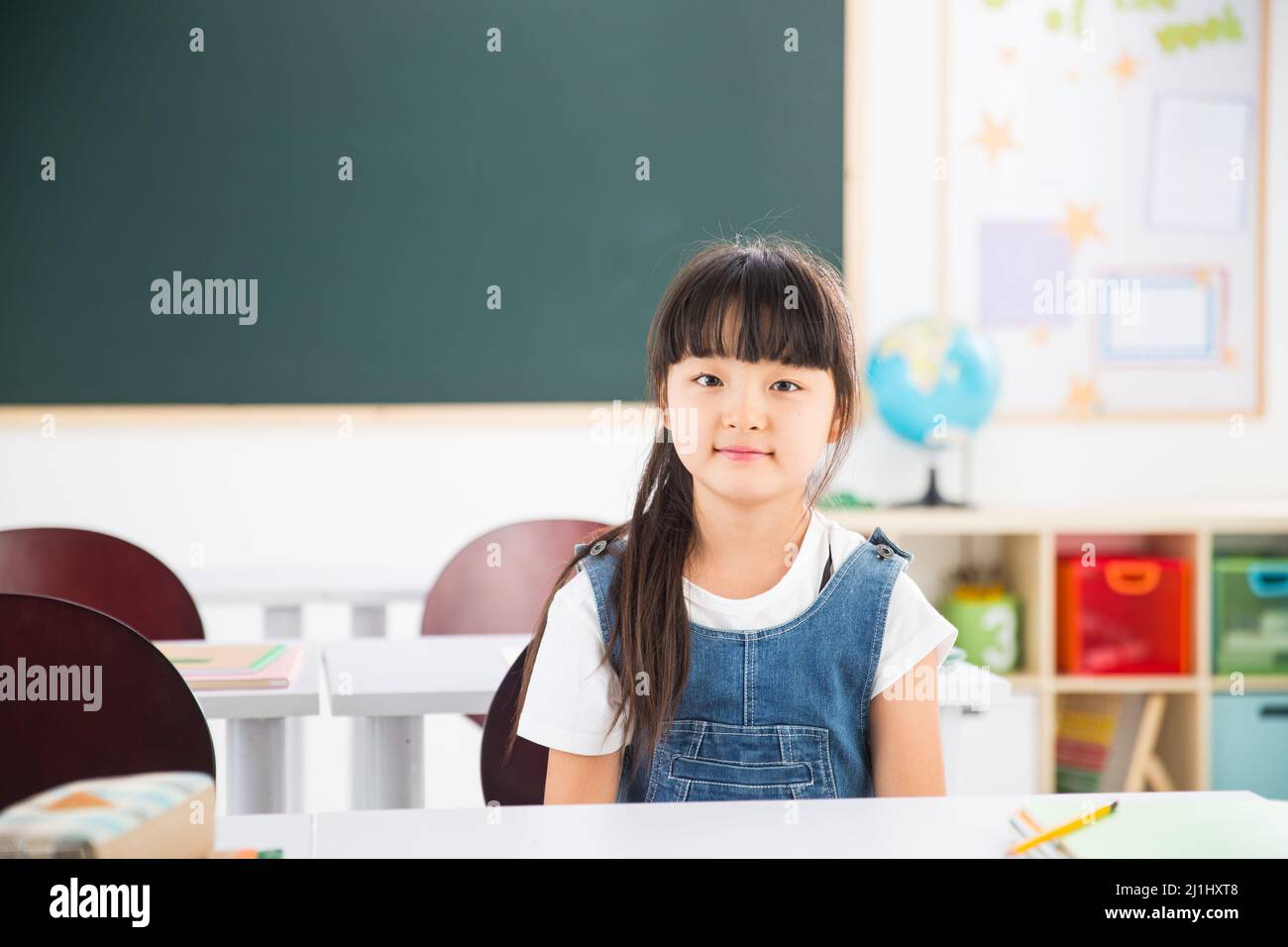 Primary school girls in the classroom Stock Photo - Alamy