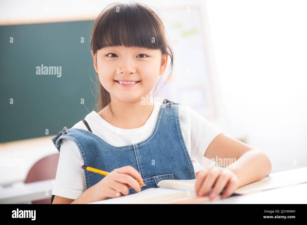 Primary school girls in the classroom Stock Photo - Alamy