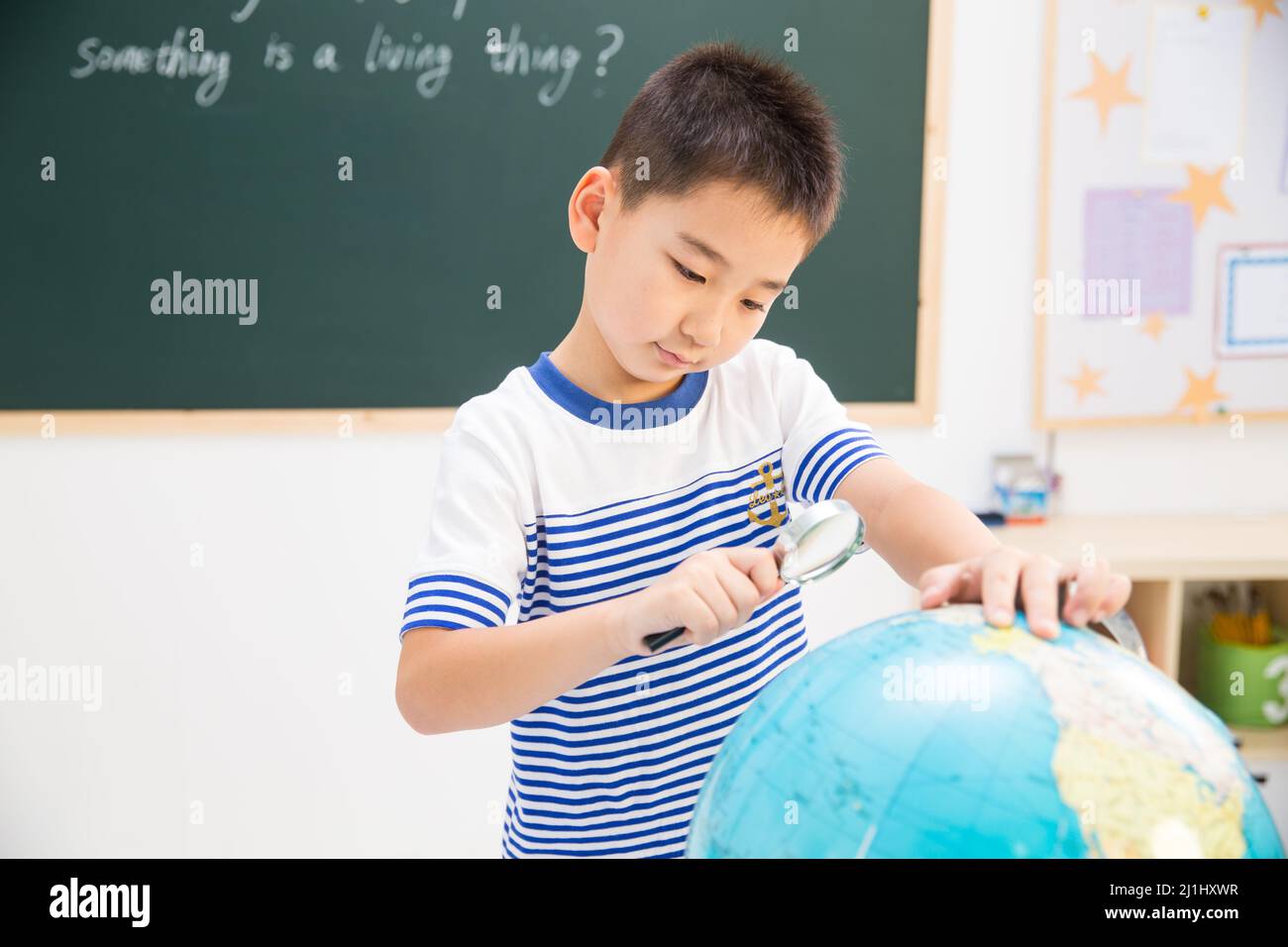 Primary school boy in the classroom Stock Photo - Alamy