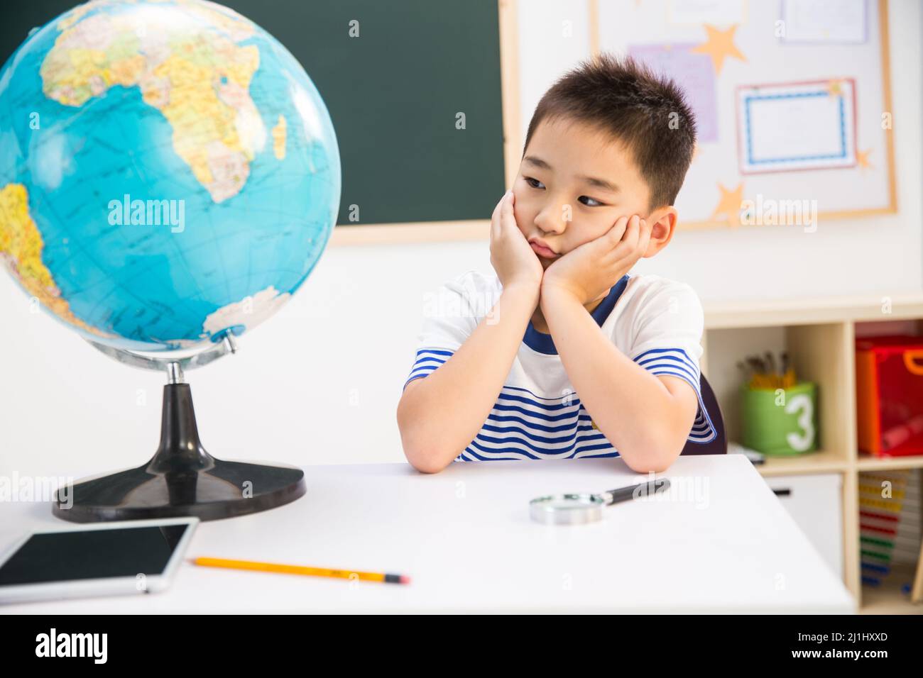 Primary school boy in the classroom Stock Photo - Alamy