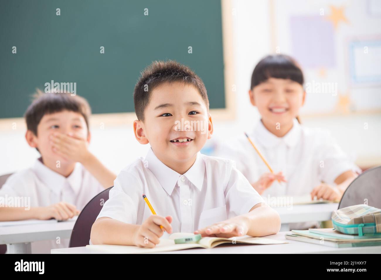 Elementary school students in the classroom learning Stock Photo - Alamy