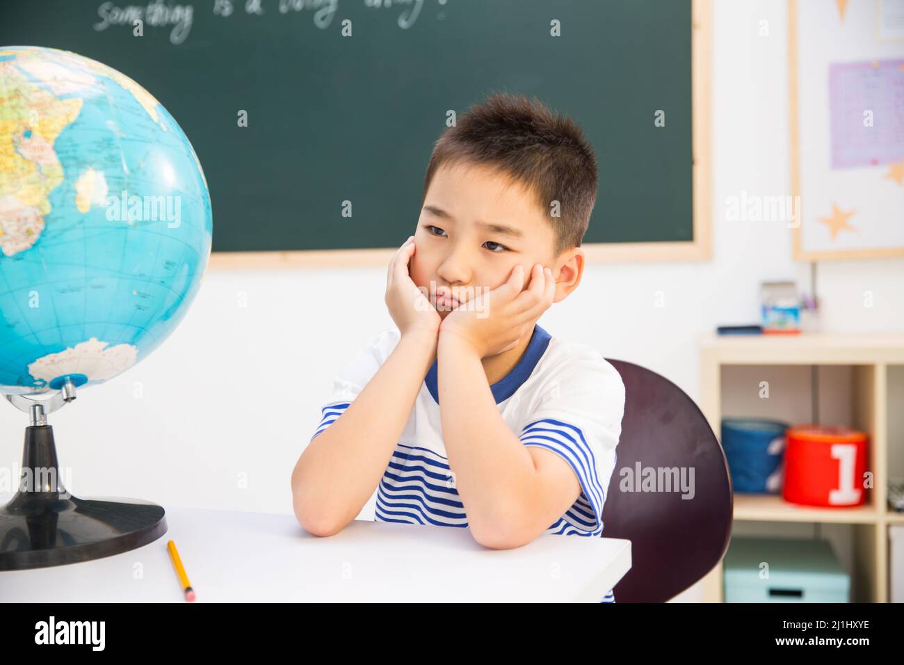 Primary school boy in the classroom Stock Photo - Alamy