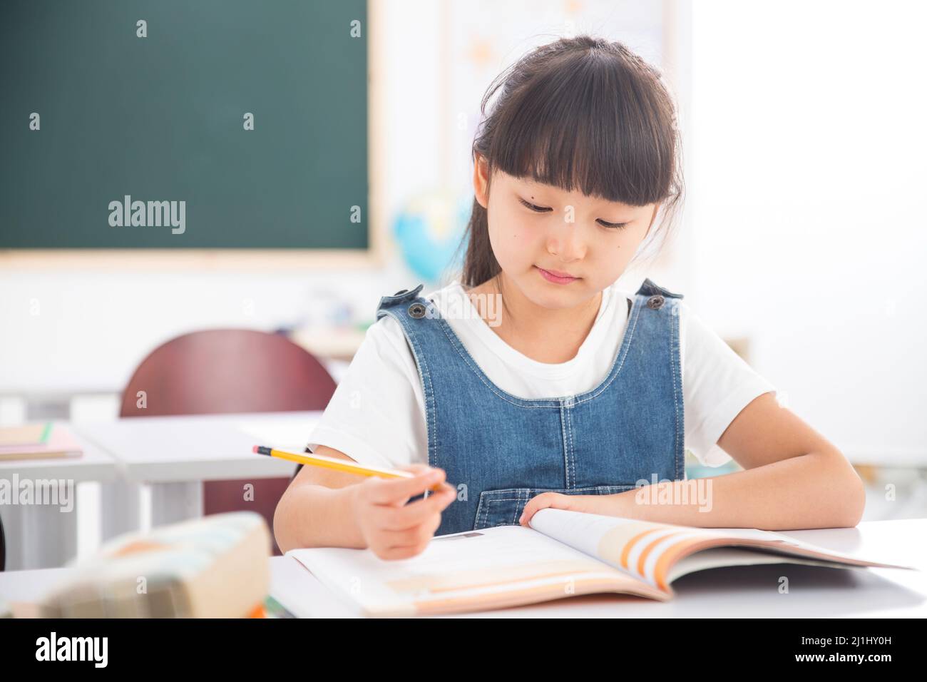 Primary school girls in the classroom Stock Photo - Alamy