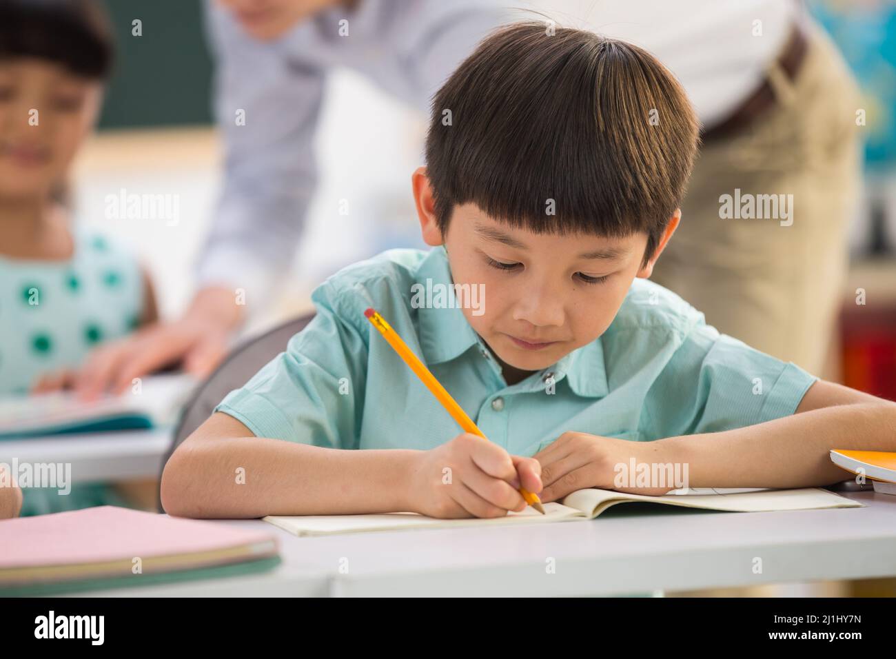 Primary school boy in the classroom study Stock Photo - Alamy