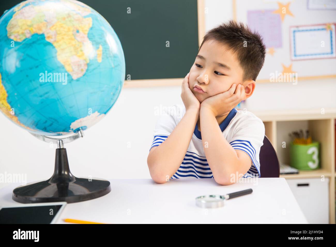 Primary school boy in the classroom Stock Photo - Alamy