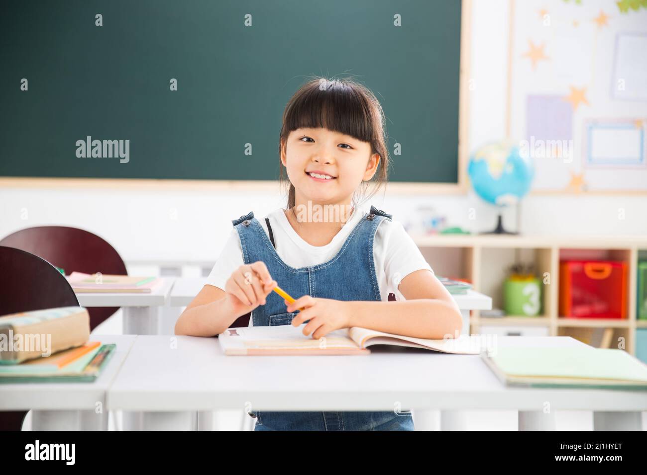 Primary school girls in the classroom Stock Photo - Alamy