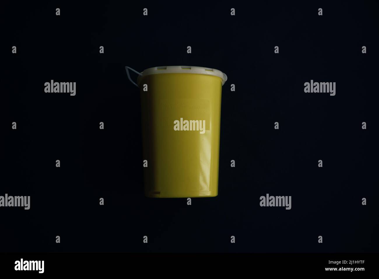 yellow container for used syringes and needles isolated Stock Photo - Alamy