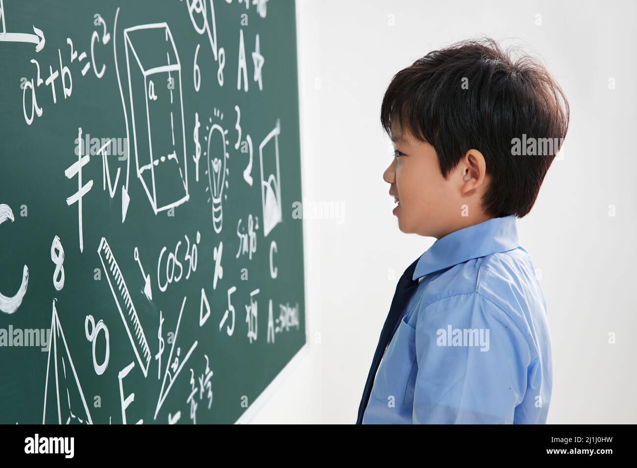 Primary school boys study the math problem on the blackboard Stock ...