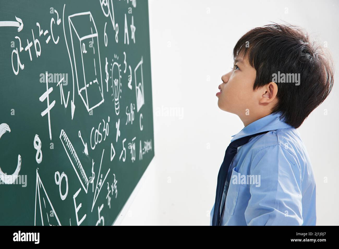 Primary school boys study the math problem on the blackboard Stock ...