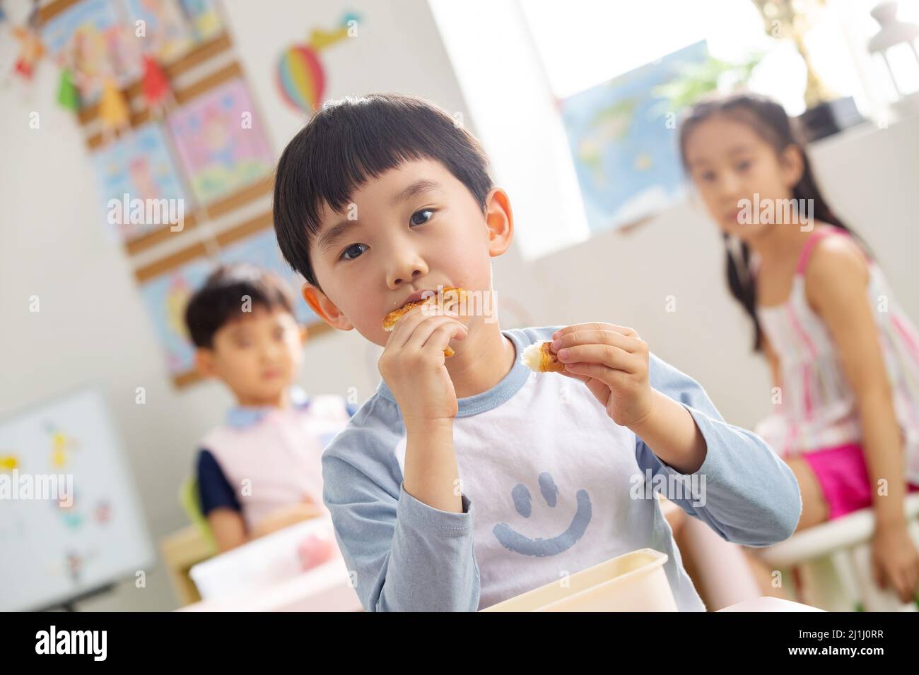 Kindergarten children eat Stock Photo - Alamy