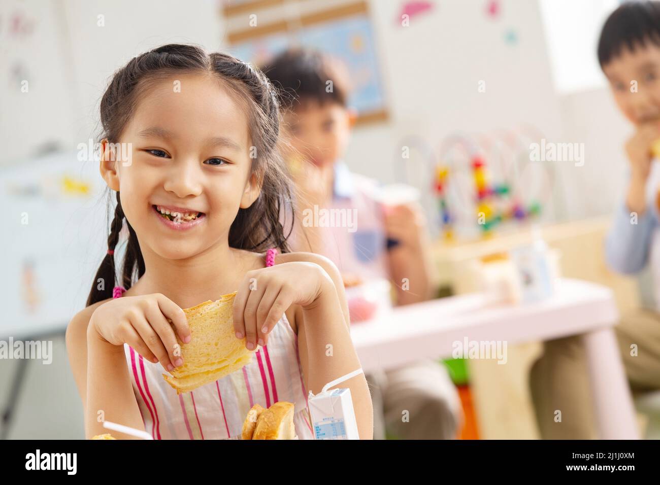 Kindergarten children eat Stock Photo - Alamy