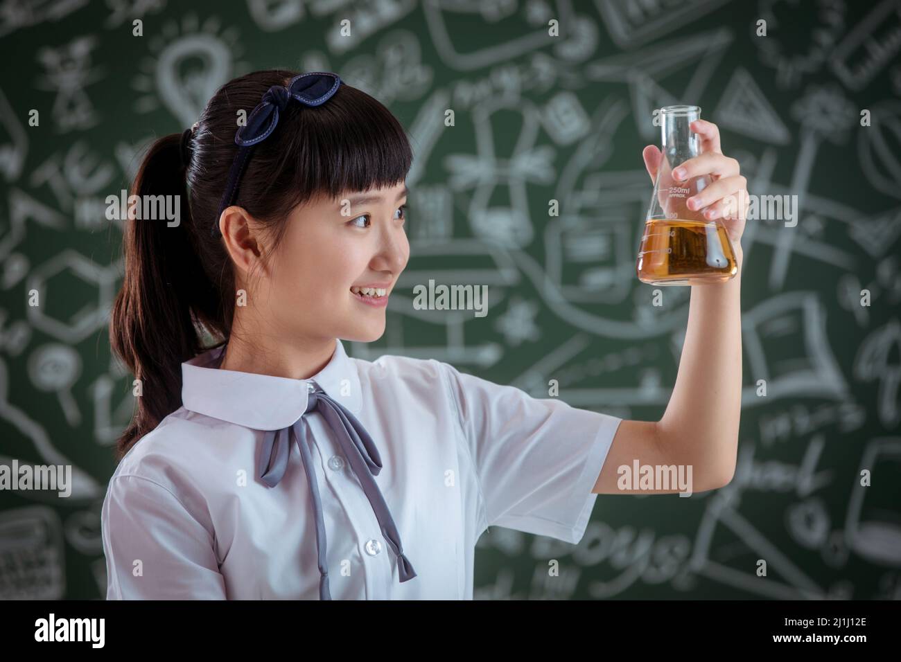 Primary school girls holding a beaker Stock Photo - Alamy
