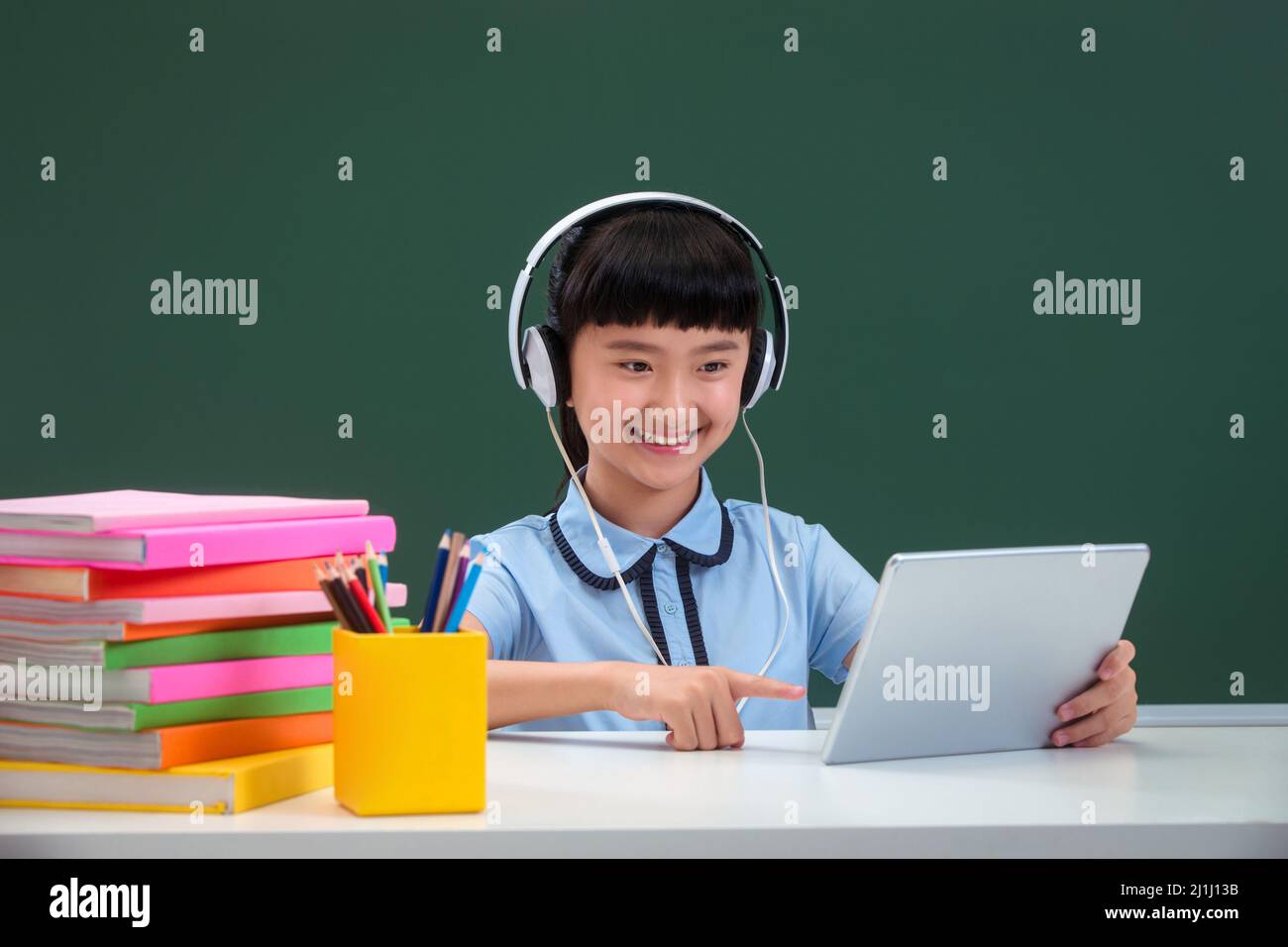 Primary school girls online learning Stock Photo - Alamy