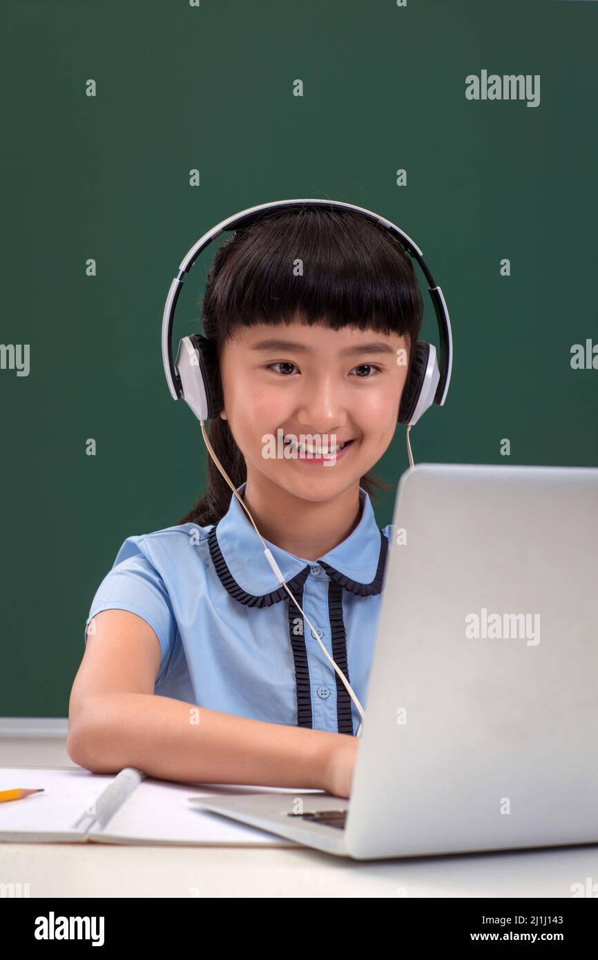 Primary school girls online learning Stock Photo - Alamy