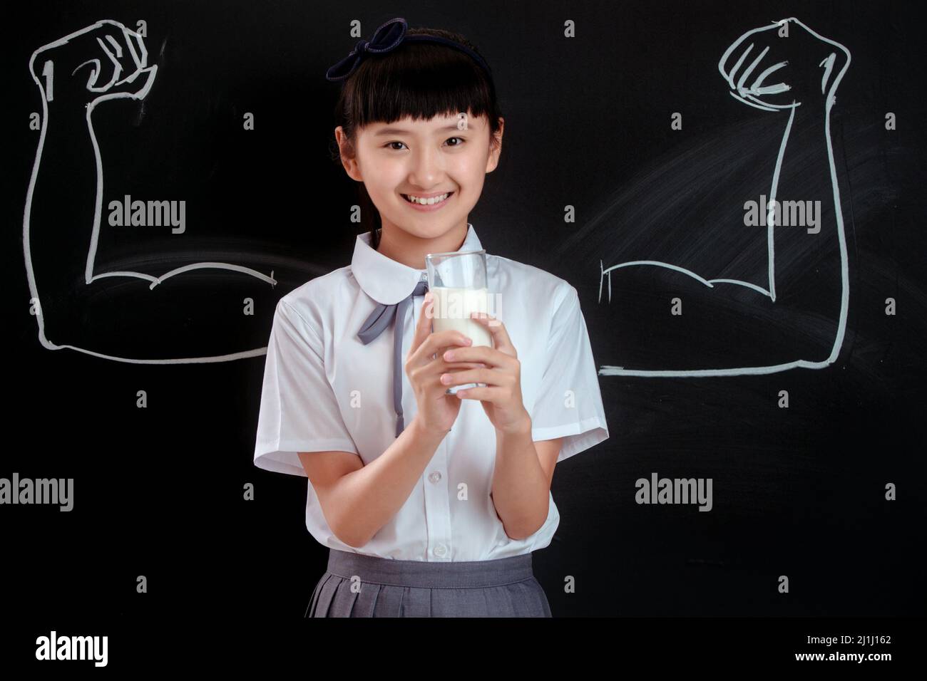 Primary schoolgirl drink milk Stock Photo - Alamy