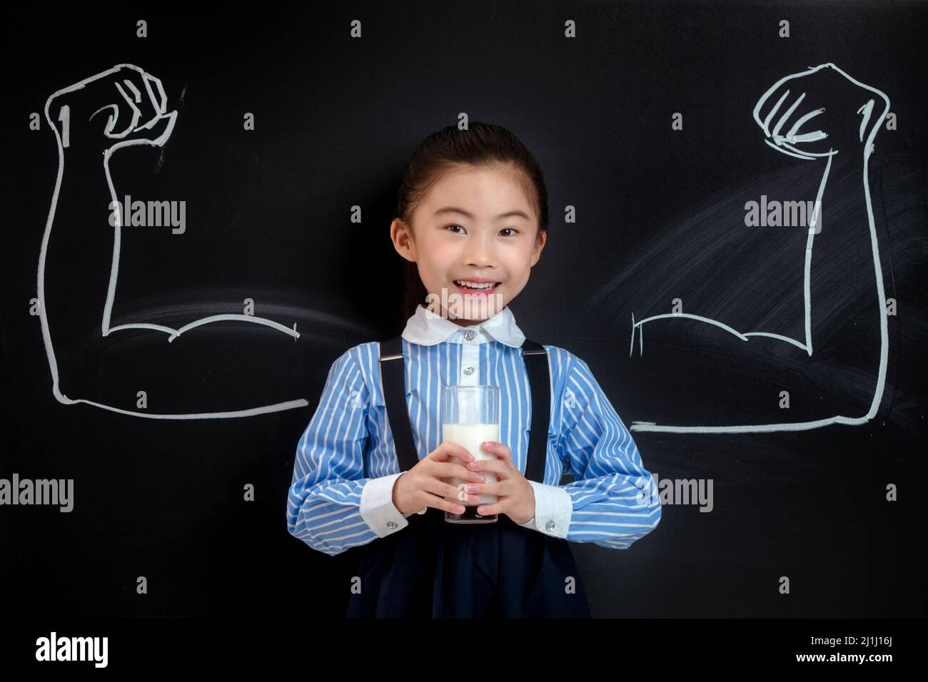 Primary schoolgirl drink milk Stock Photo - Alamy
