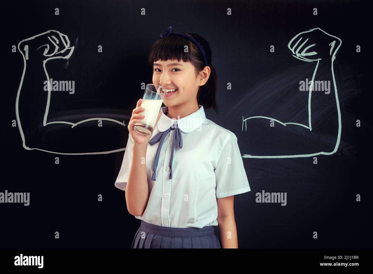 Primary schoolgirl drink milk Stock Photo - Alamy