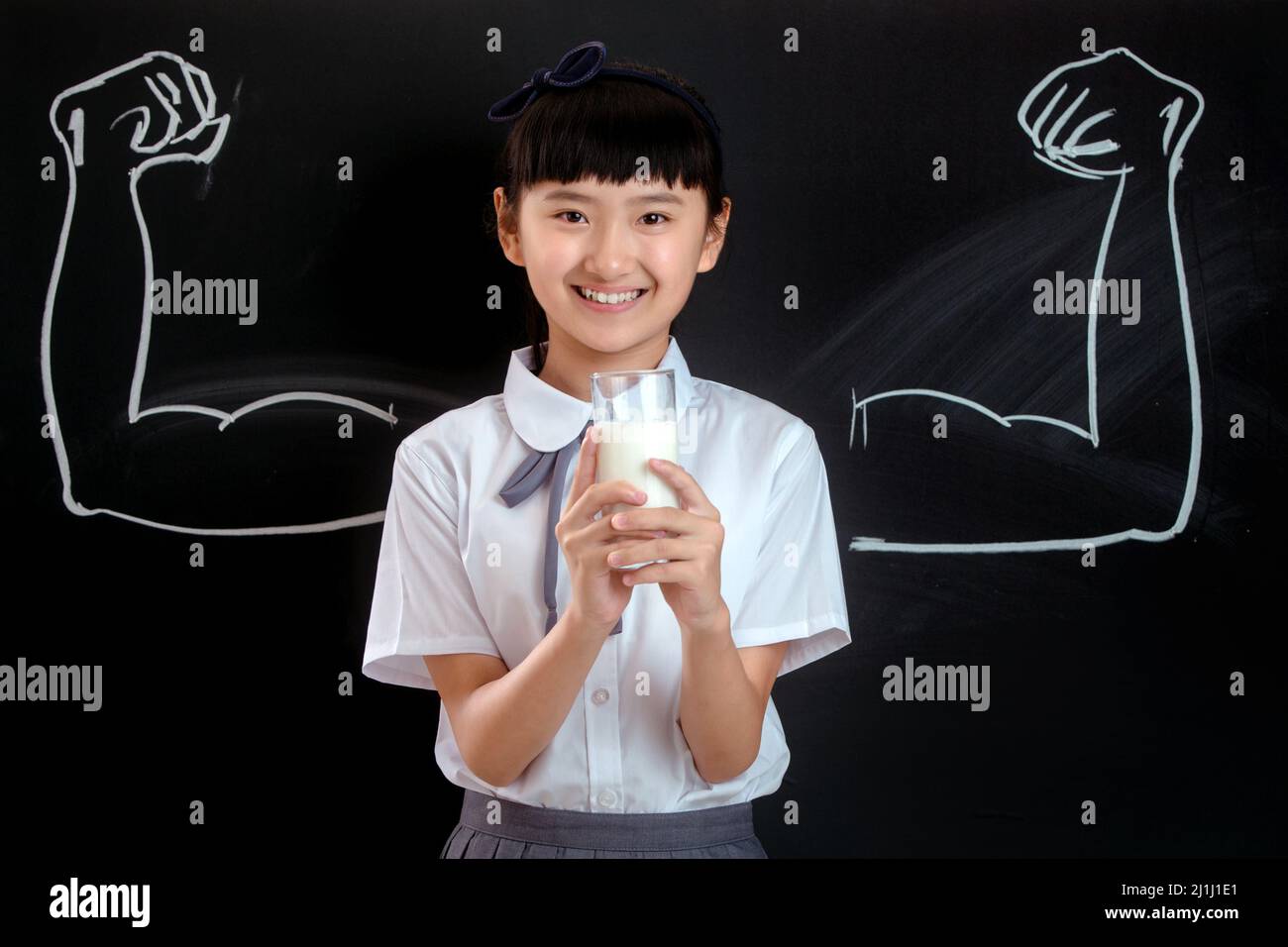 Primary schoolgirl drink milk Stock Photo - Alamy