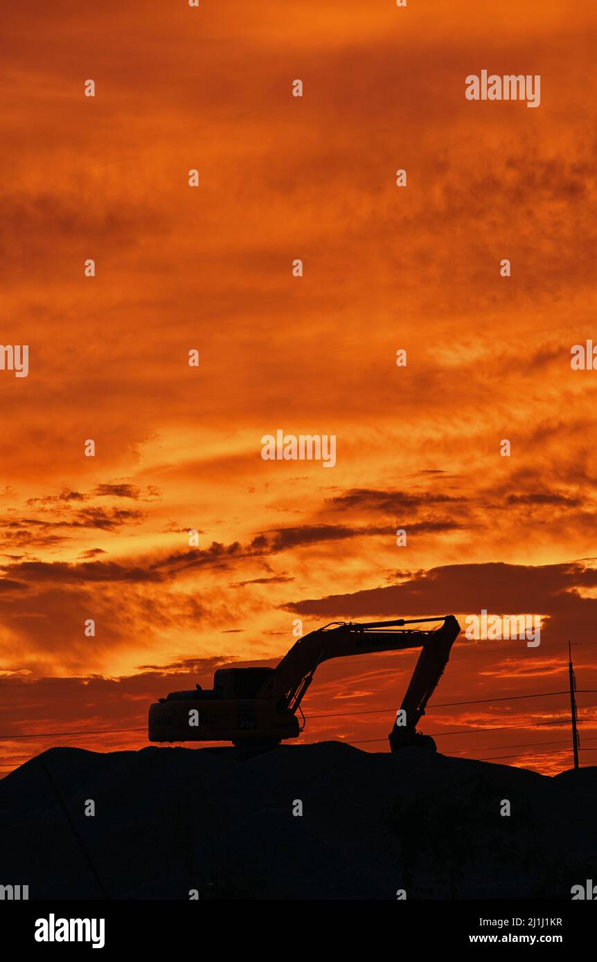 The backhoe silhouette at sunset Stock Photo - Alamy