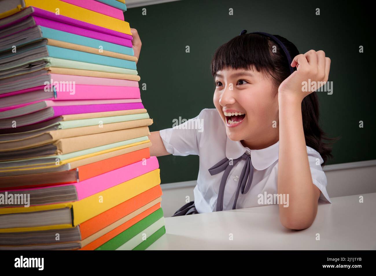 Primary school girls and textbooks Stock Photo - Alamy
