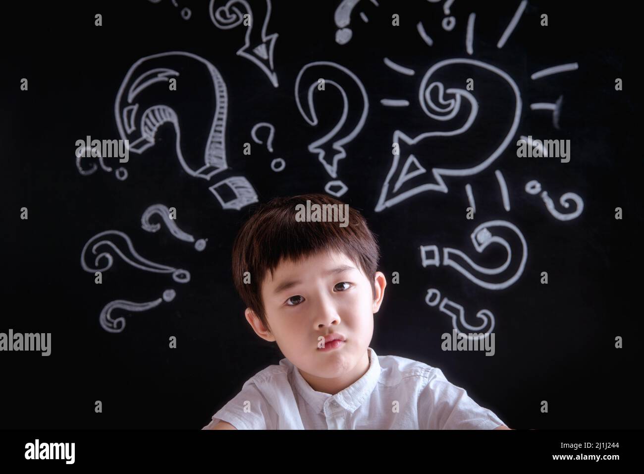 Primary school boy in thinking Stock Photo - Alamy