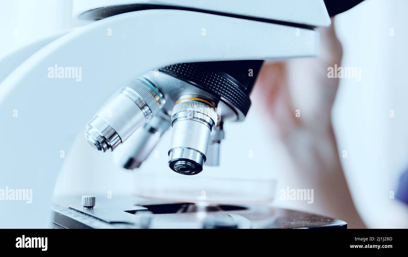 Closeup microscope laboratory, blood test running, virus check banner ...