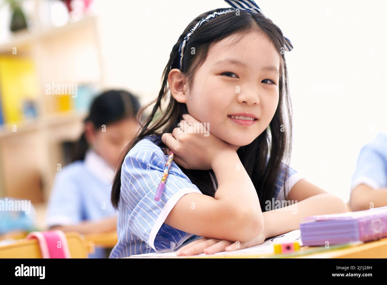 Primary school girls in the classroom Stock Photo - Alamy