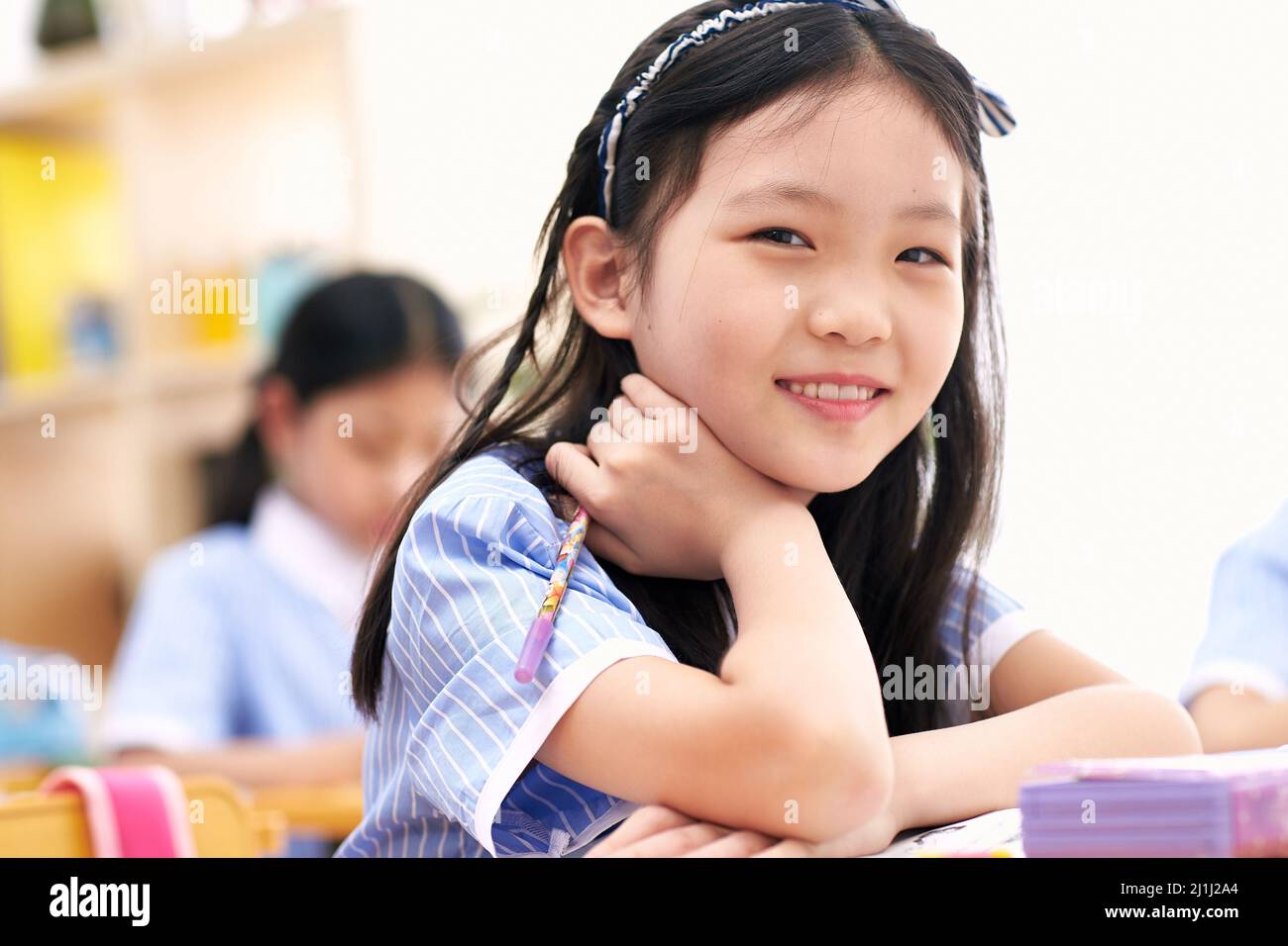 Primary school girls in the classroom Stock Photo - Alamy