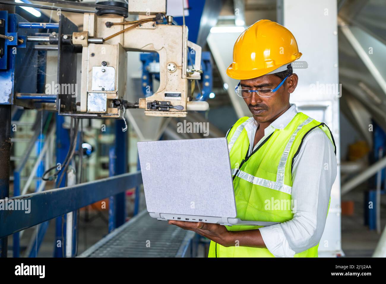 industrial worker busy using laptop at workplace - concept of ...