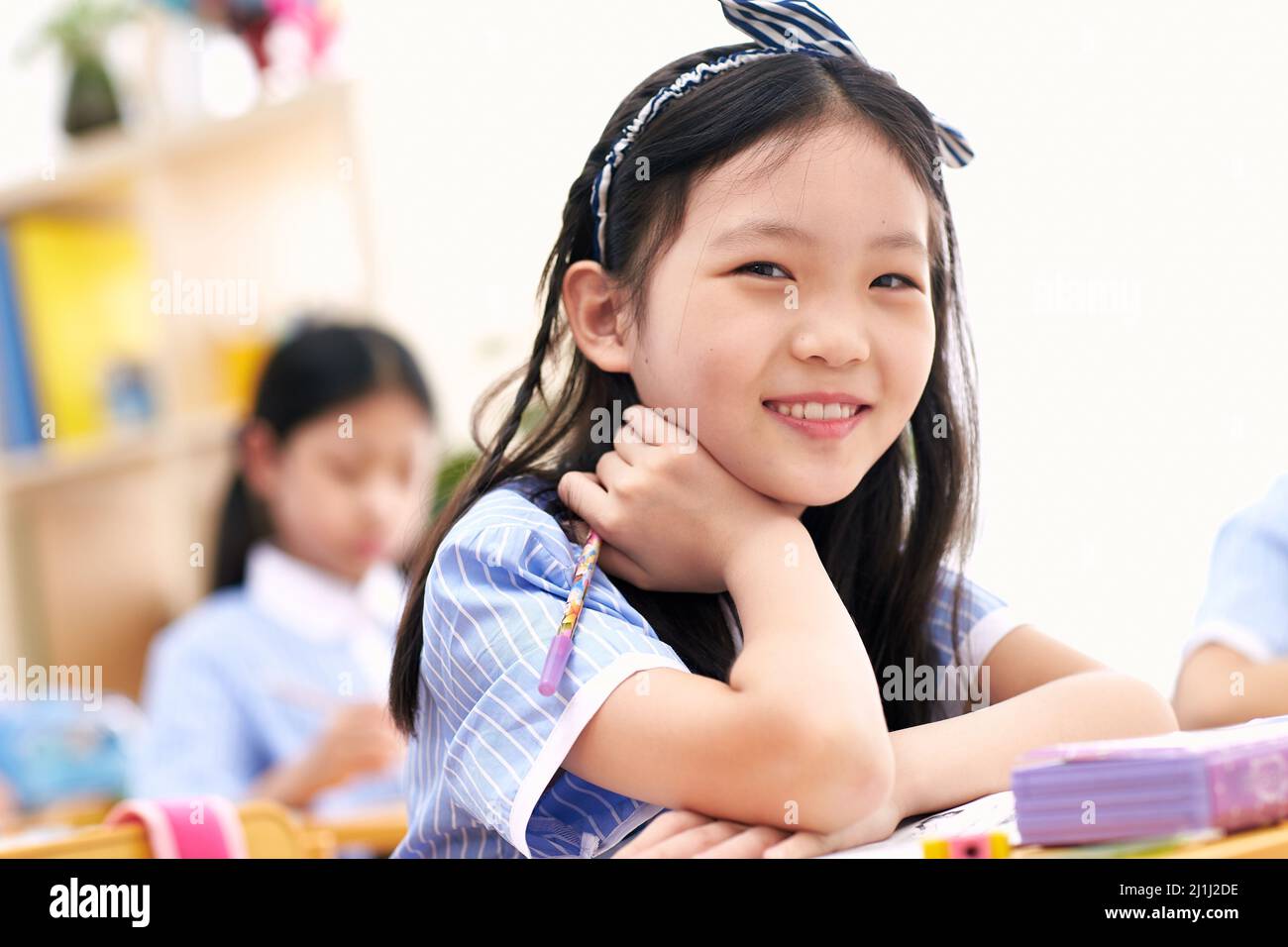 Primary school girls in the classroom Stock Photo - Alamy