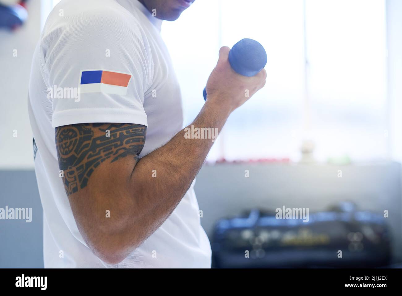Toning his biceps. Shot of an unrecognizable man going through his ...
