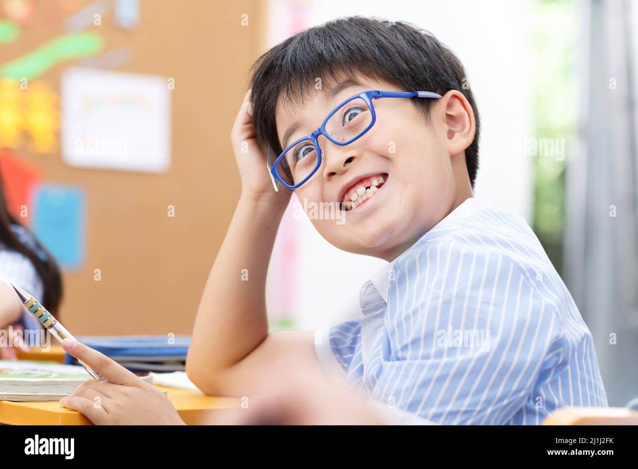 Primary school boy in the classroom Stock Photo - Alamy