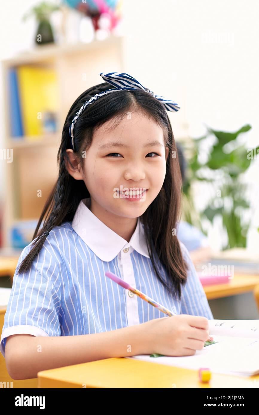 Primary school girls in the classroom Stock Photo - Alamy