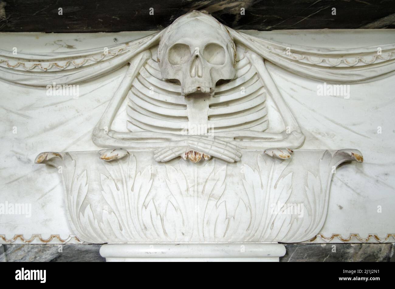 A marble carving from the 18th century showing a skeleton resting his ...
