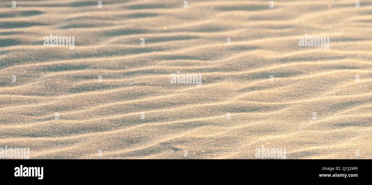 Banner of a pastel texture of fine sand on a beach forming waves on the ...