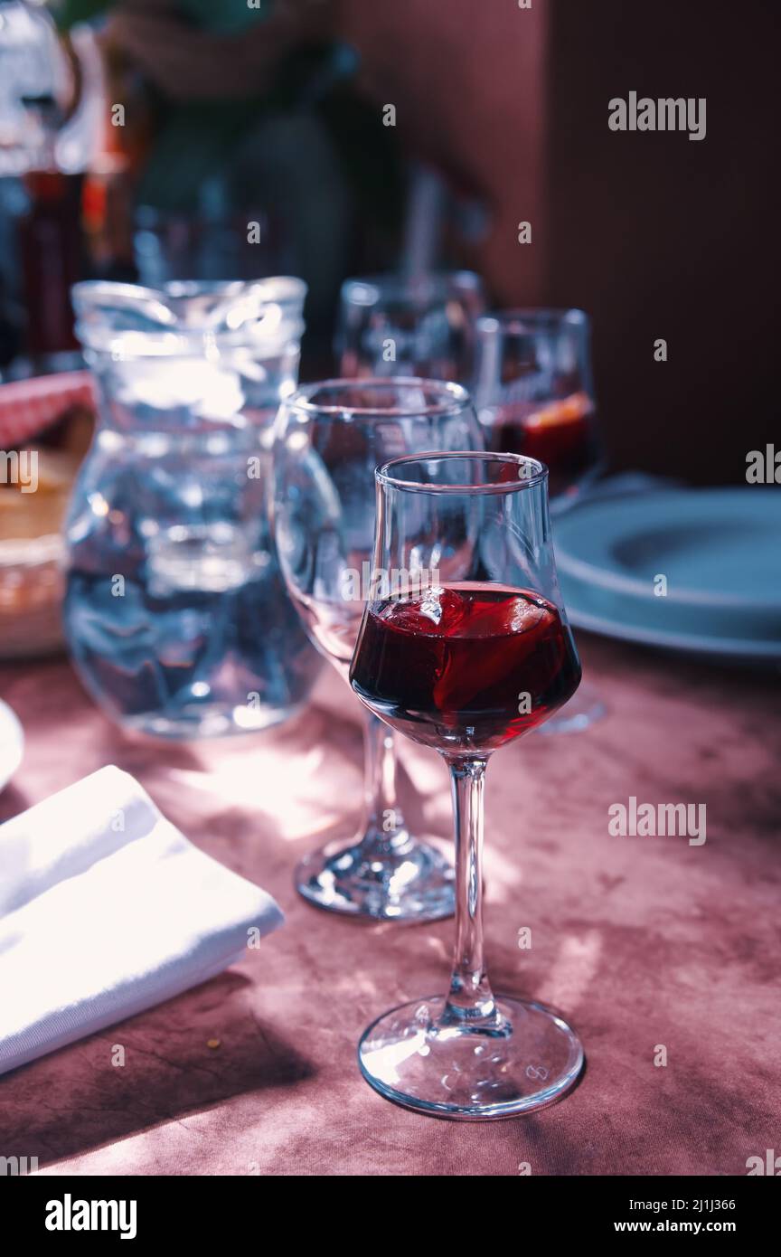Table in restaurant with glass of aperitif in front Stock Photo - Alamy