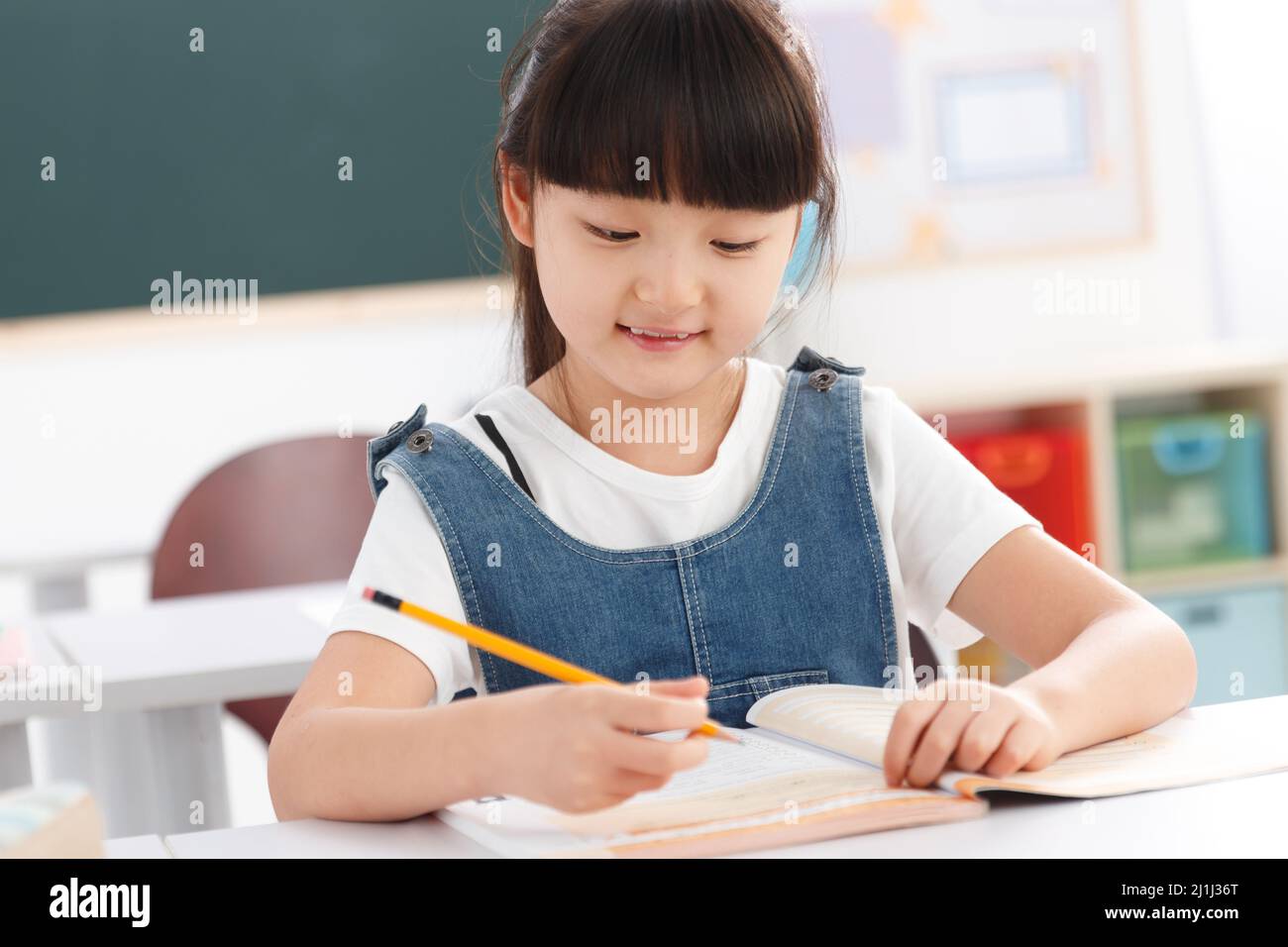 Primary school girls in the classroom Stock Photo - Alamy