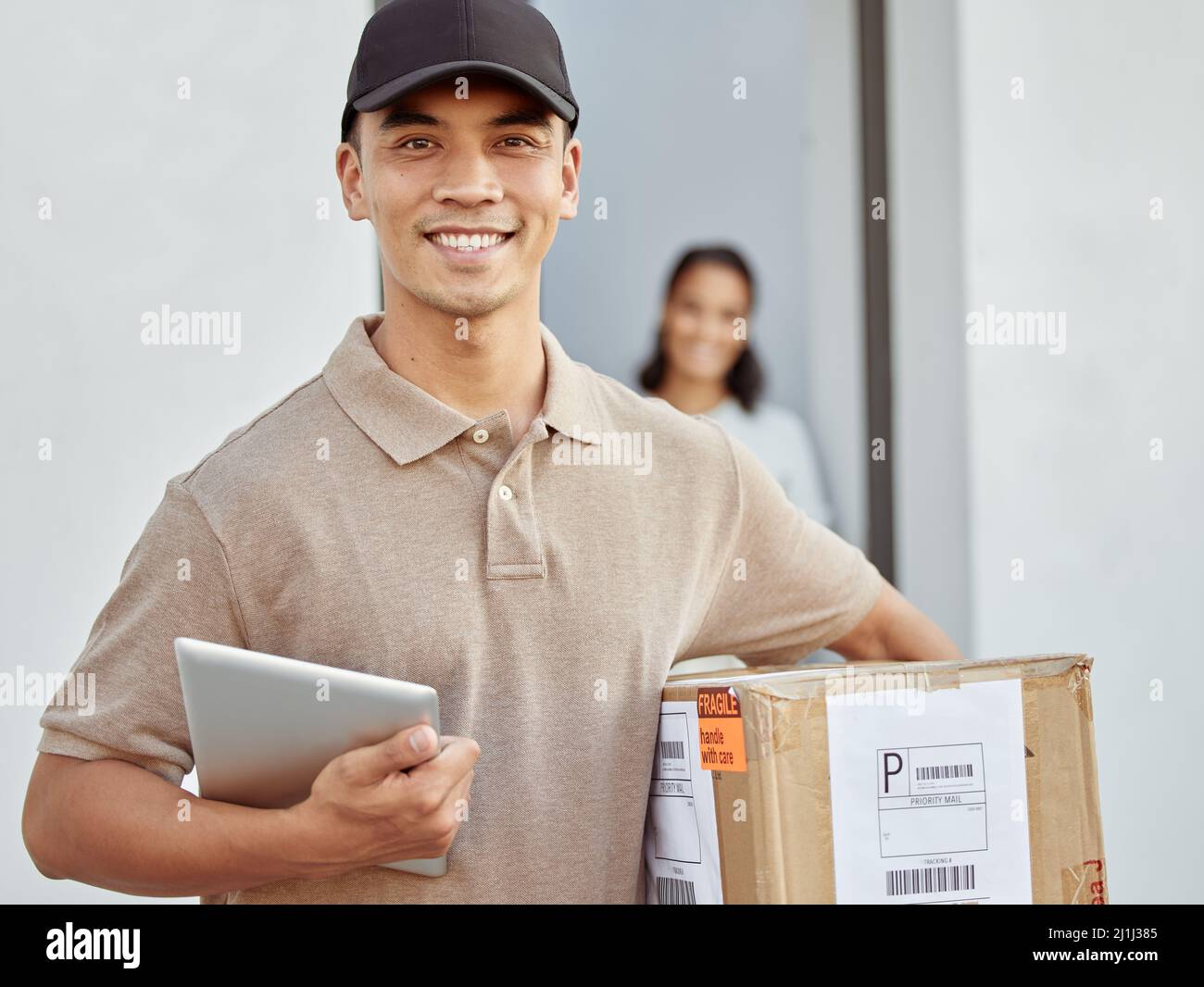 Proud to bring customers their packages. Shot of a young delivery man ...