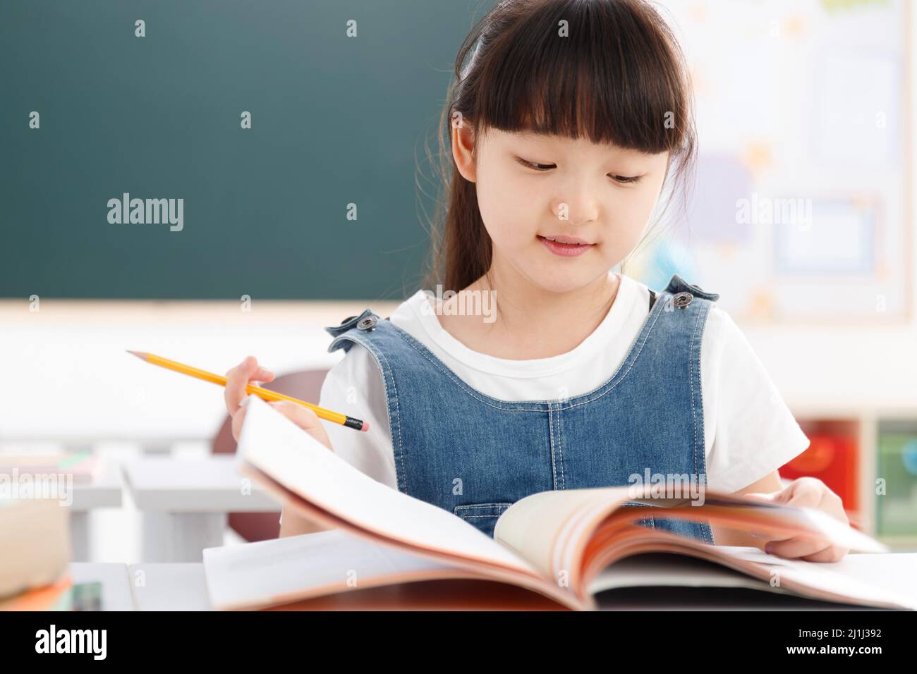 Primary school girls in the classroom Stock Photo - Alamy