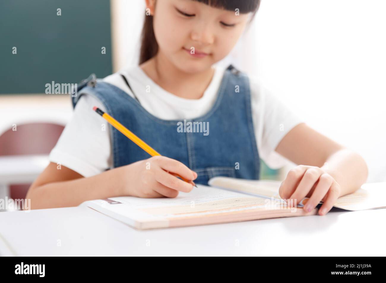 Primary school girls in the classroom Stock Photo - Alamy