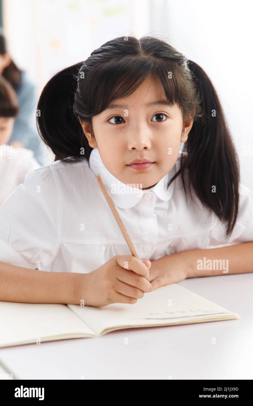 Primary school girls learn in the classroom Stock Photo - Alamy