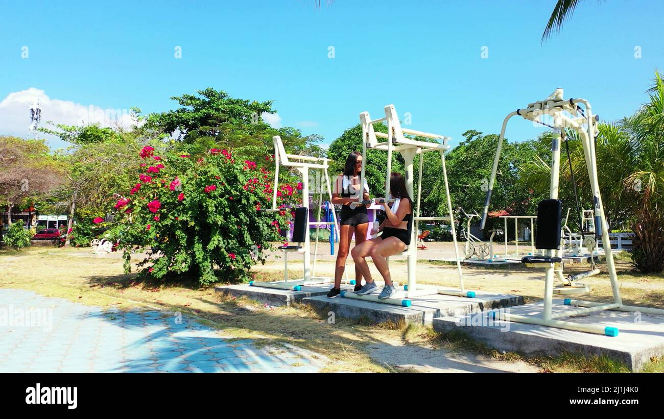 A distant view of two females working out at the beach in Koh Samui ...