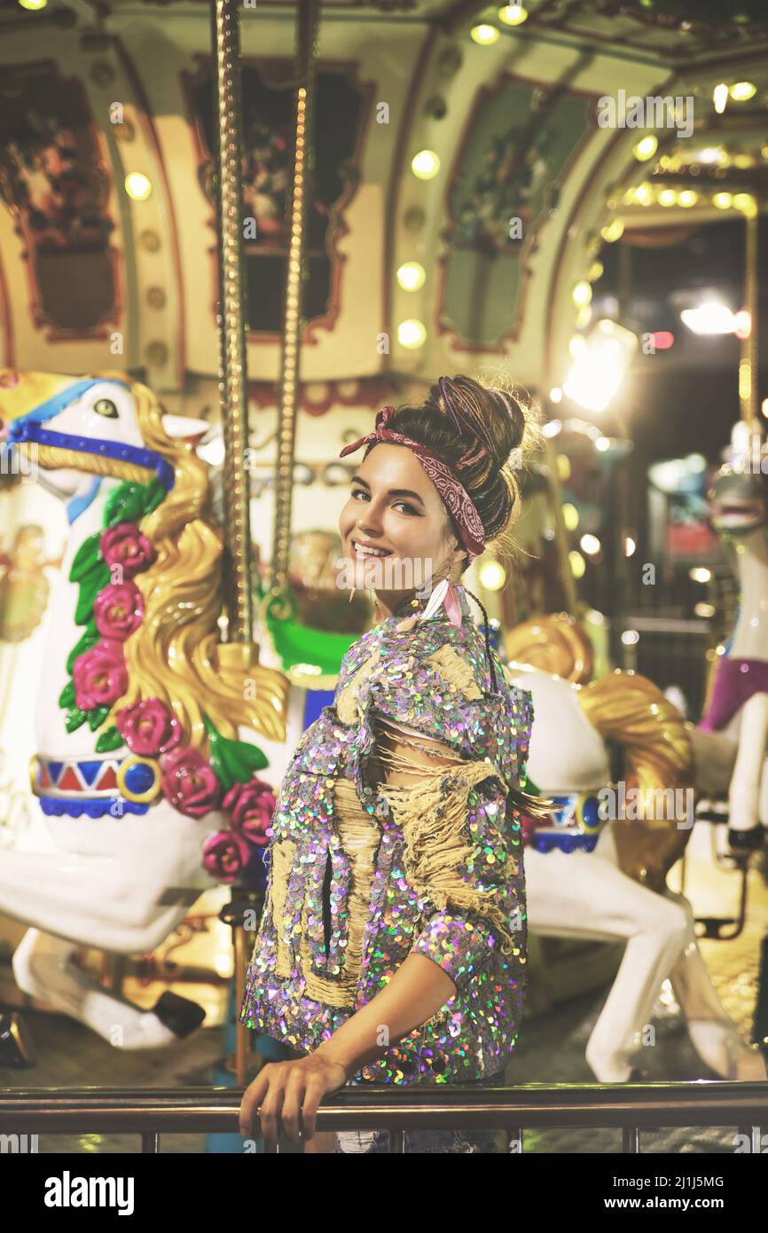 Stylish woman wearing sparkling jacket on the carousel Stock Photo - Alamy