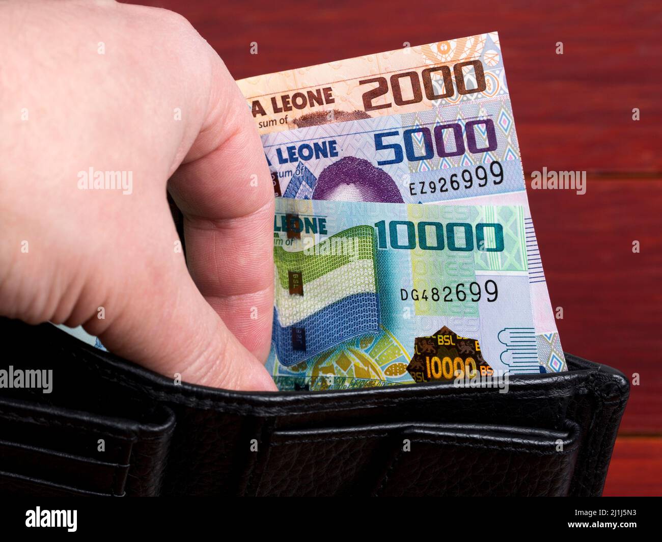 Sierra Leonean money - leone in the black wallet Stock Photo - Alamy