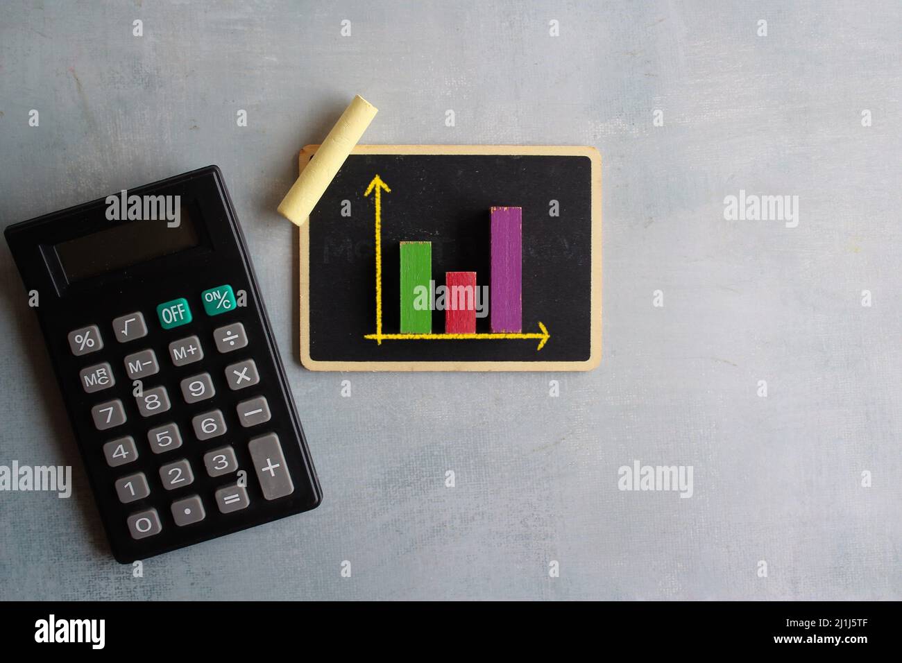 Sales chart graph on chalkboard and calculator. Business and sales ...