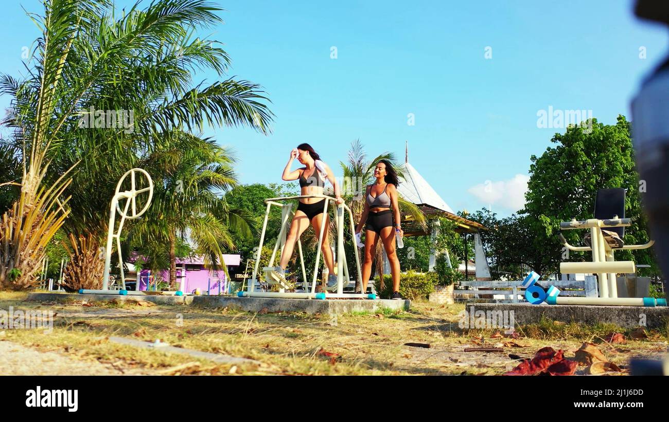 A distant view of two females working out at the beach in Koh Samui ...